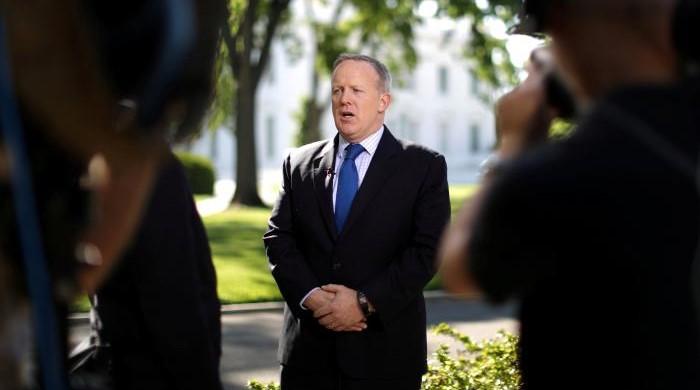 Cutouts of US official Sean Spicer's head 'sprout' in bushes across America