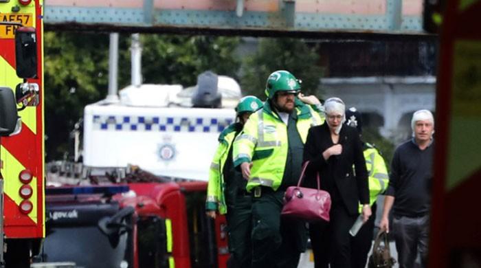 Second man arrested over London train attack, threat level eased