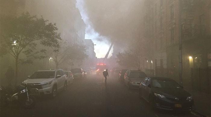 Five wounded as Manhattan building fire rages on