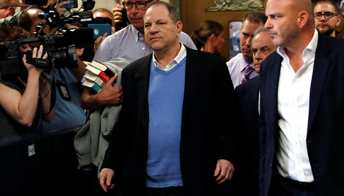 Film mogul Weinstein appears handcuffed in court to face rape charges