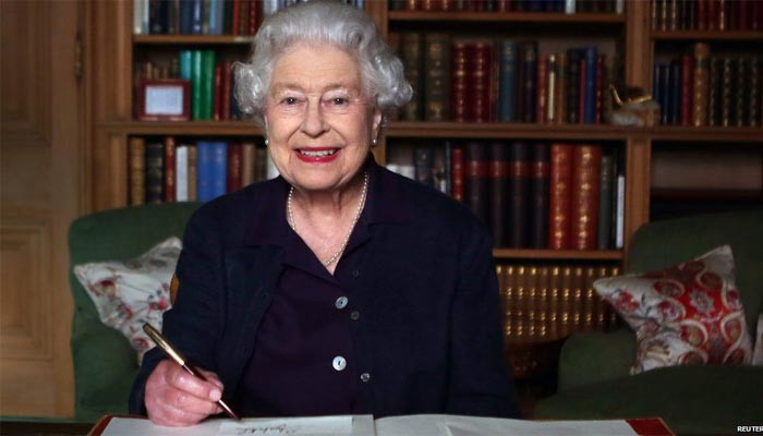 Queen Elizabeth signs her message to the Commonwealth