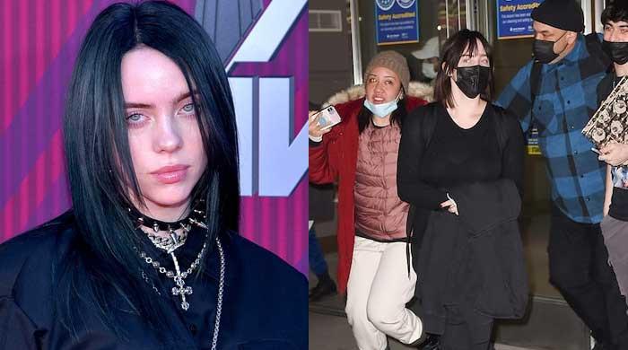 Billie Eilish's bodyguards protect her from overzealous fans at JFK Airport