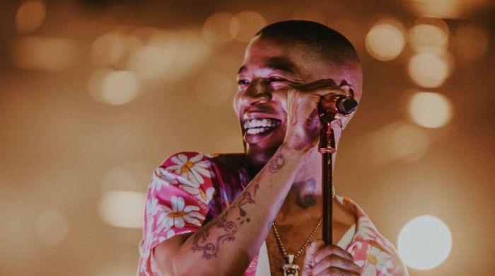 Kid Cudi walks off the stage after hit by bottles