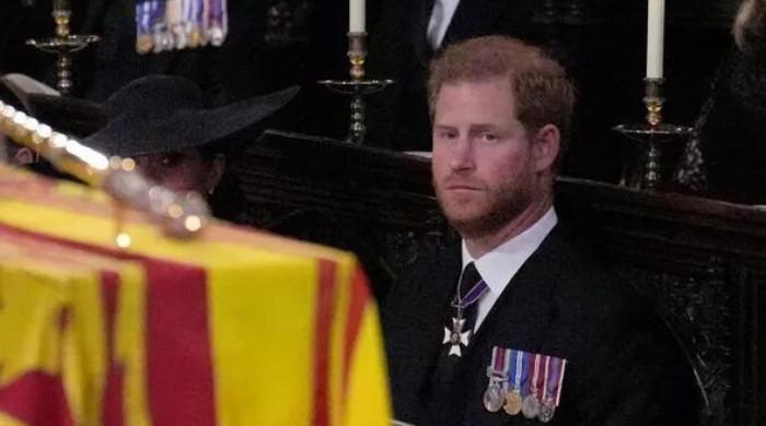 Prince Harry’s face spells sorrow as he watches Queen being lowered in ...