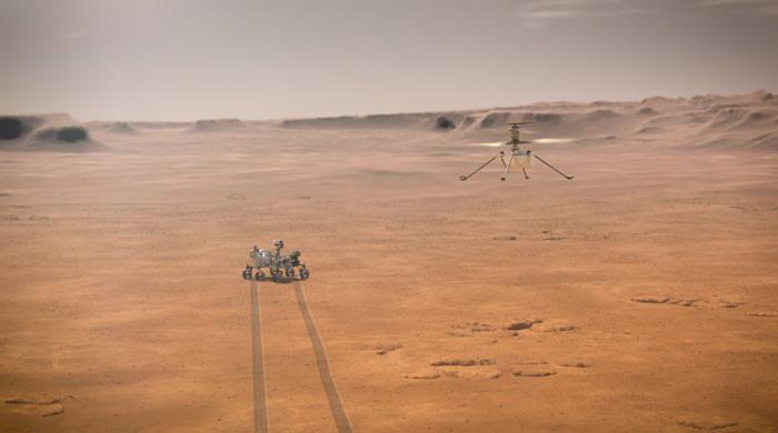 Exploring Mars: NASA Ingenuity helicopter flying over desert