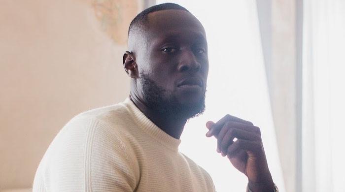 Stormzy finds himself stuck between two cars in new awkward photos