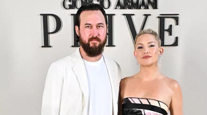 Kate Hudson poses with fiancé Danny Fujikawa at Giorgio Armani Show