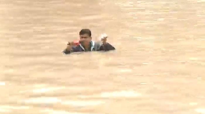 WATCH: Journalist reports in neck-deep waters during heavy rains