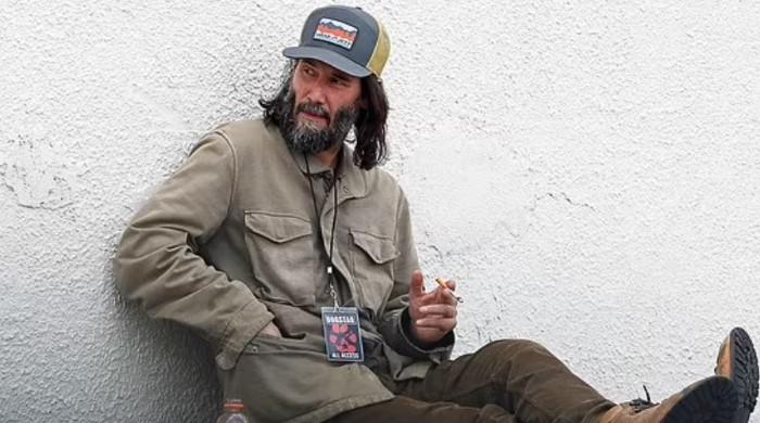 Keanu Reeves seen smoking as he relaxes before Dogstar’s concert in L.A.
