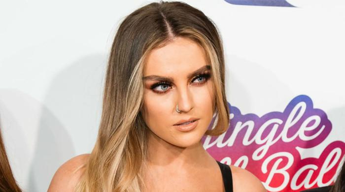 Perrie Edwards dons a gold jumpsuit as she performs her new solo single